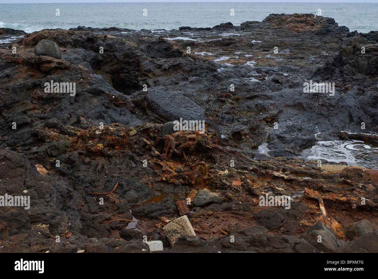 Rotting garbage lays on the shores of Glass Beach, Hawaii, the site of ...