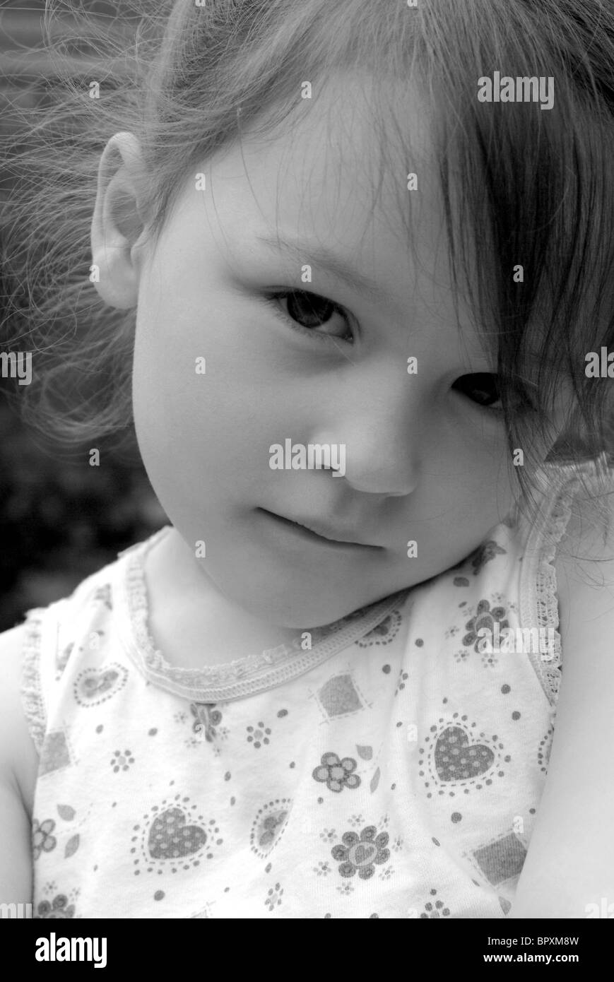 Black and white portrait of a little girl looking coy Stock Photo - Alamy
