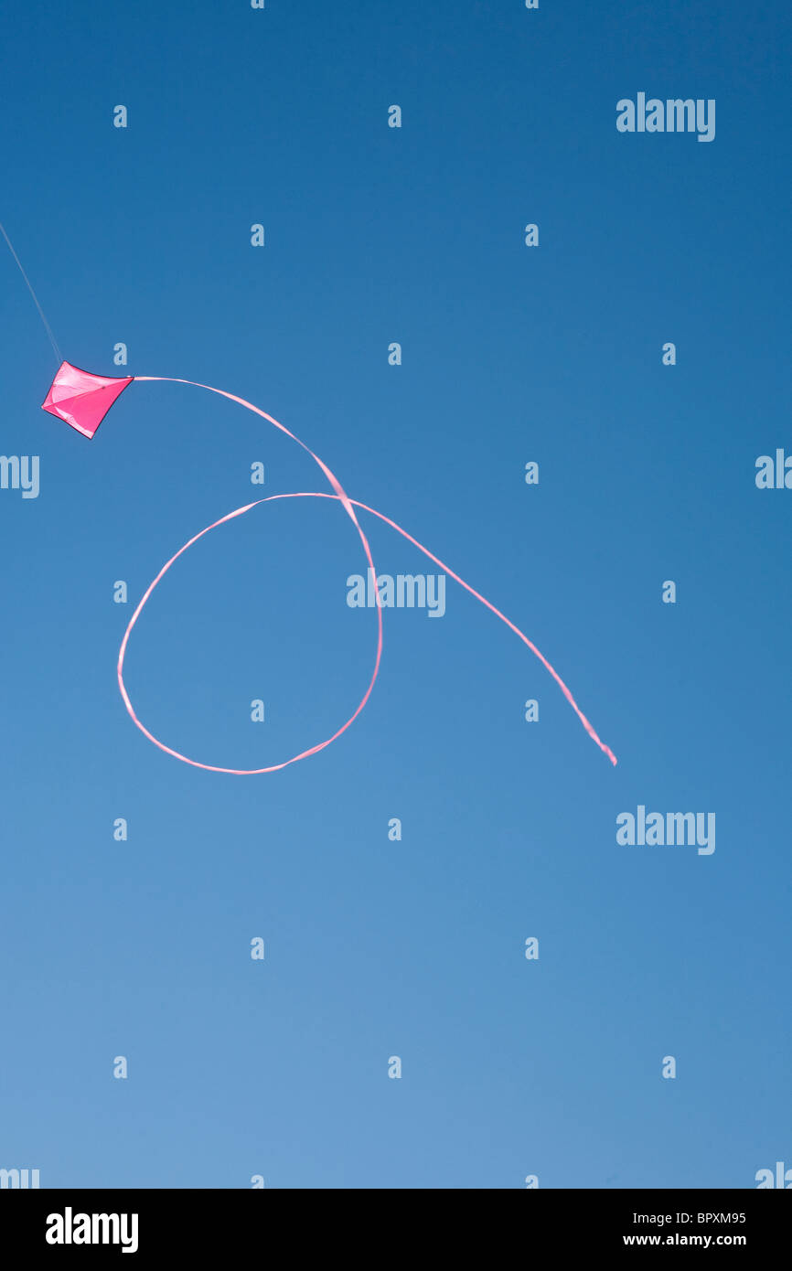kite flies in blue sky Stock Photo - Alamy