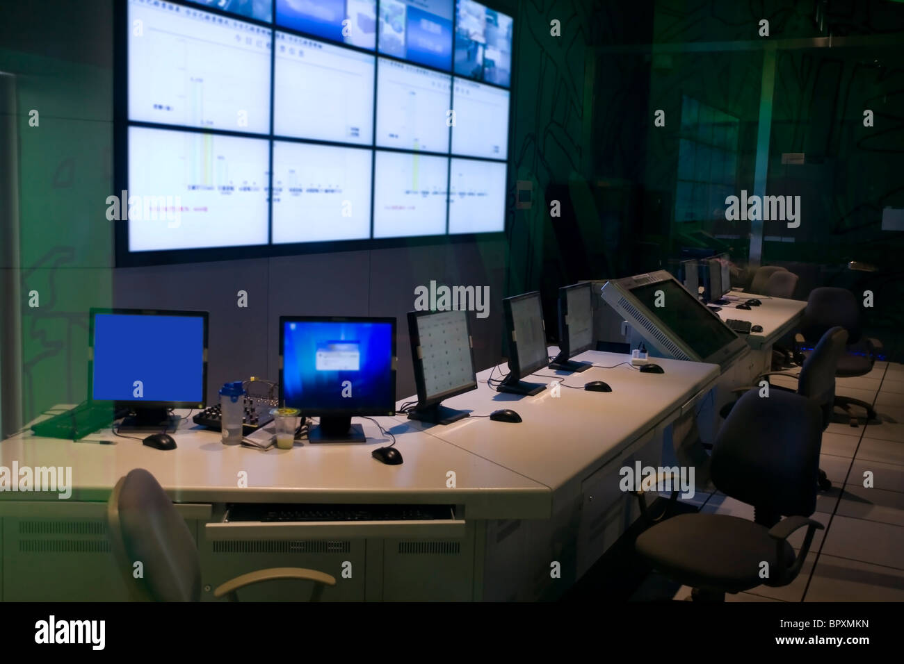 an command center with big screens and workstation Stock Photo - Alamy