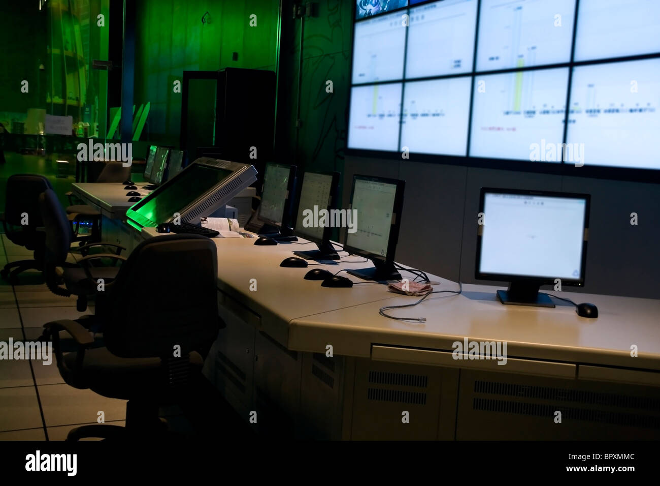 an command center with big screens and workstation Stock Photo - Alamy