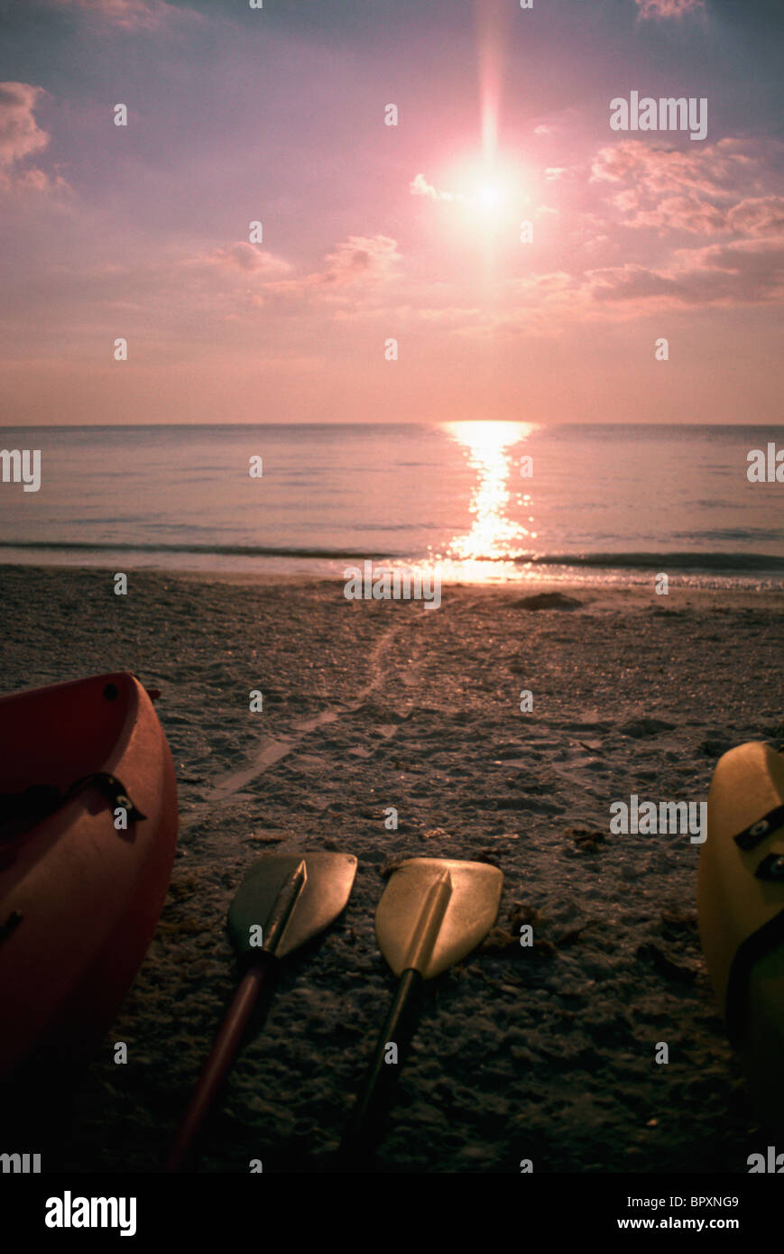 kayaks on beach at sunset Stock Photo - Alamy