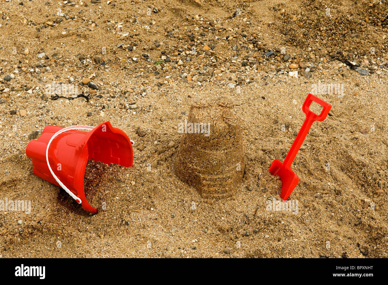 A bucket, spade and sandcastle on a beach Stock Photo - Alamy
