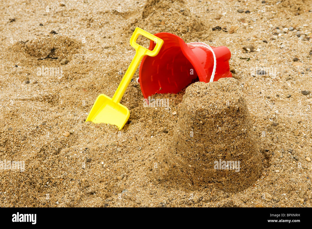 A bucket, spade and sandcastle Stock Photo - Alamy