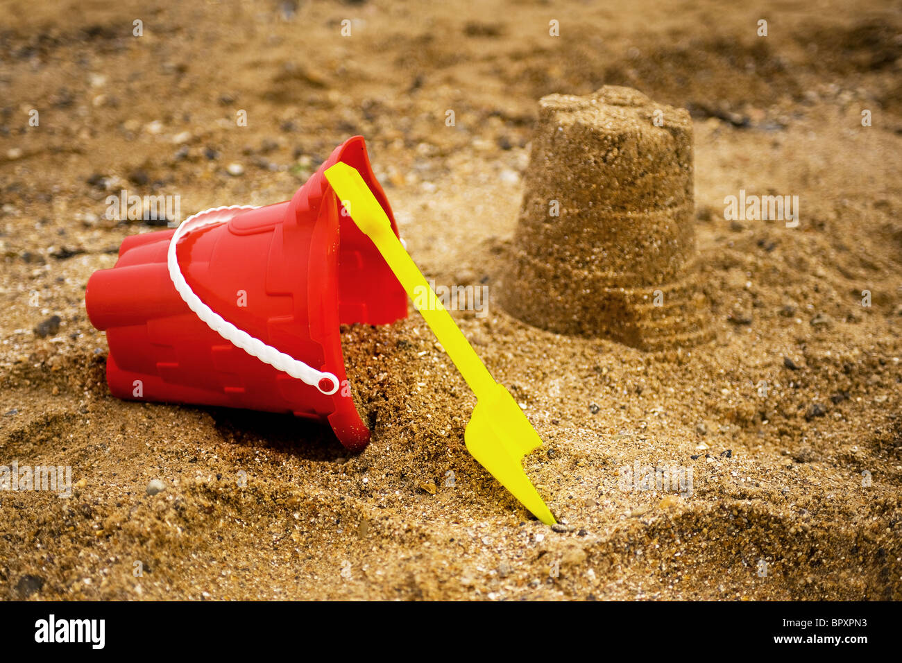 A bucket, spade and sandcastle Stock Photo - Alamy