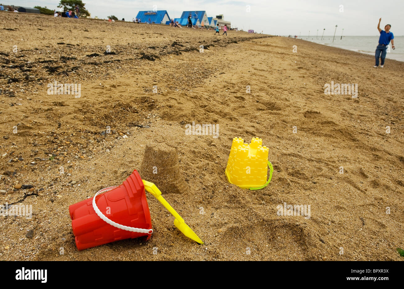 A bucket, spade and sandcastle on a beach in Southend on Sea in Essex ...