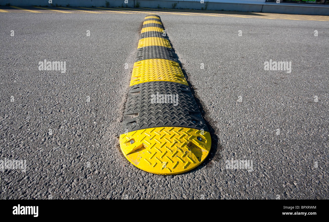 yellow striped speed bump Stock Photo - Alamy