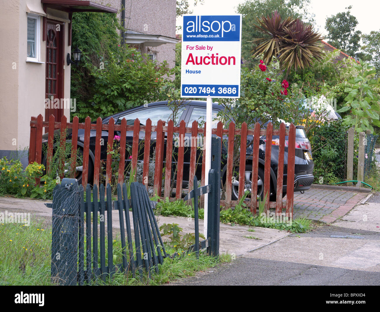 An auction sign outsde an empty house New Malden London UK Stock Photo ...
