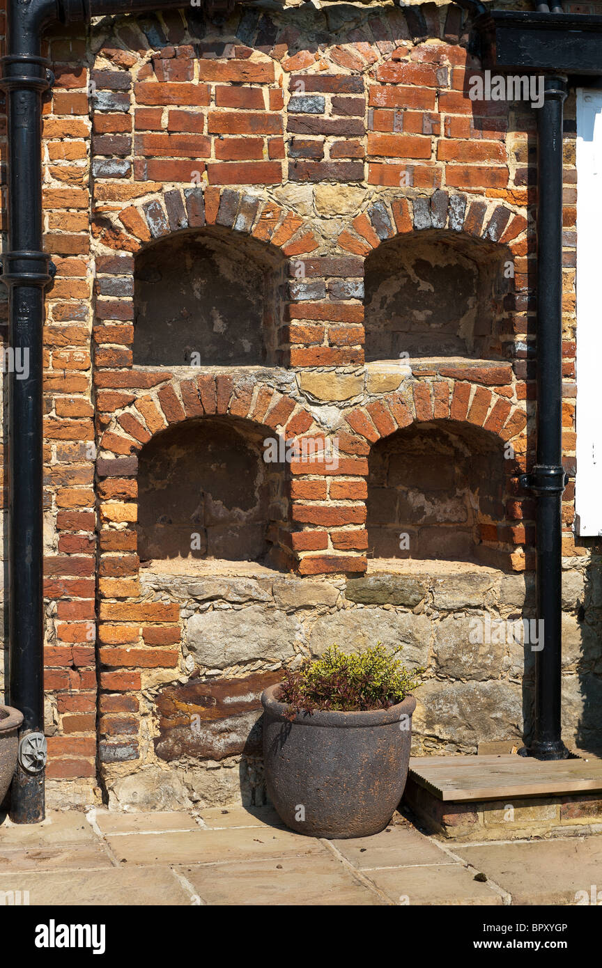 Brick beehive as per built into the wall of a house. The hive would ...