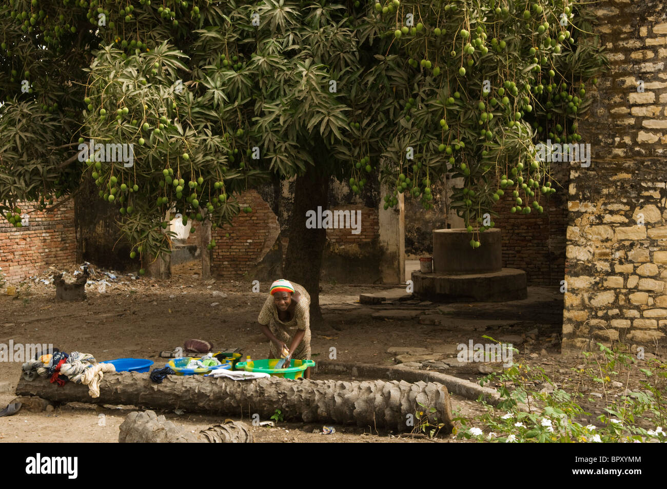 Woman washing clothes inside an old slave house, Île de Karabane ...