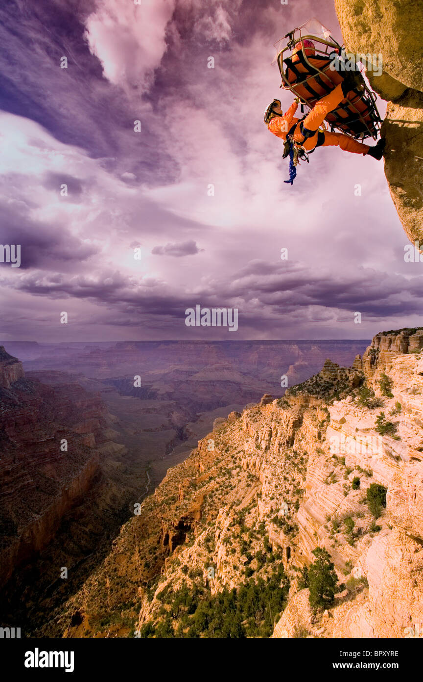 Search and Rescue climber tending litter, wide shot lowering from South ...
