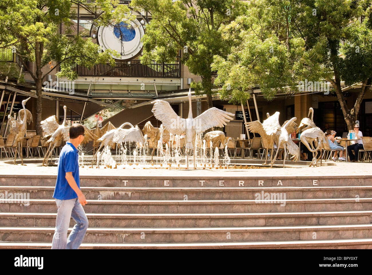Man passing statue Stock Photo - Alamy