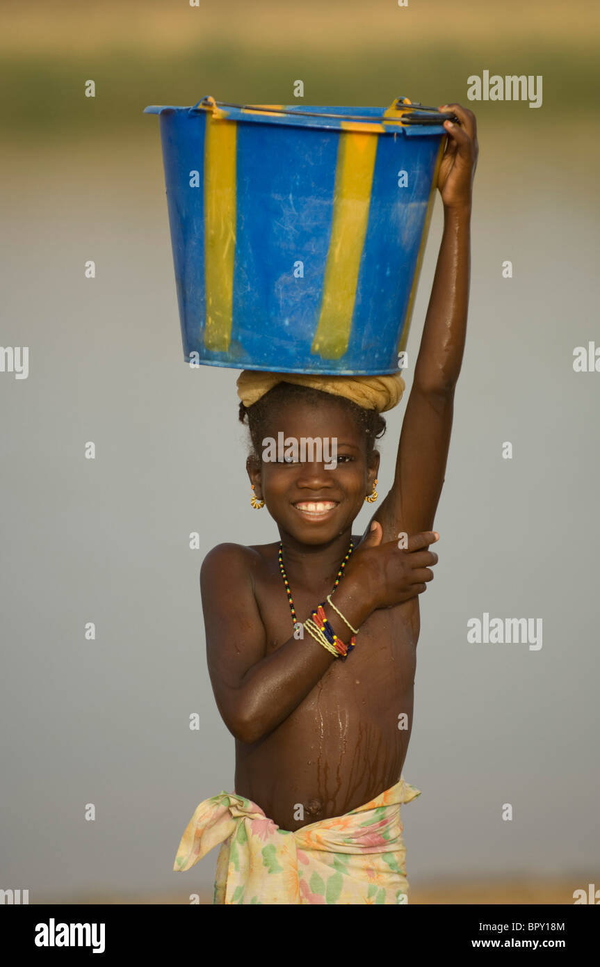 Girl carrying water from the Senegal river, Matam, Senegal Stock Photo ...