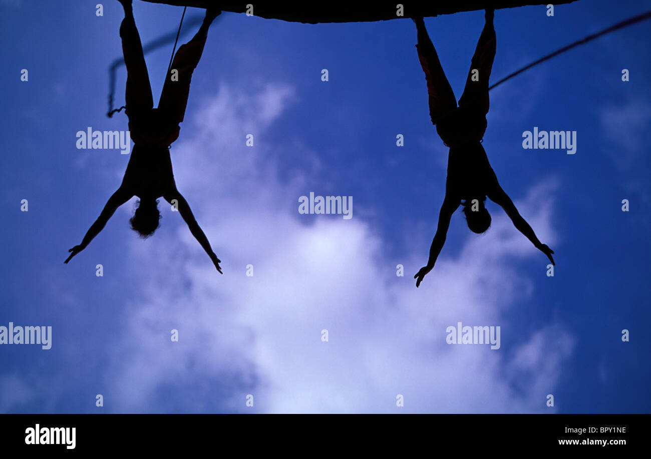 Aerial dancers perform in high angle environments while dangling from ...