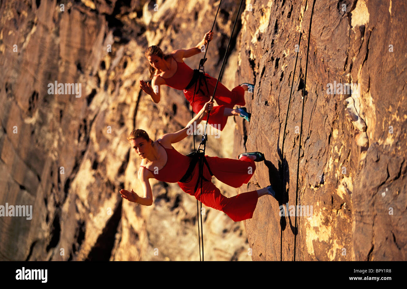 Aerial dancers perform in high angle environments while dangling from ...
