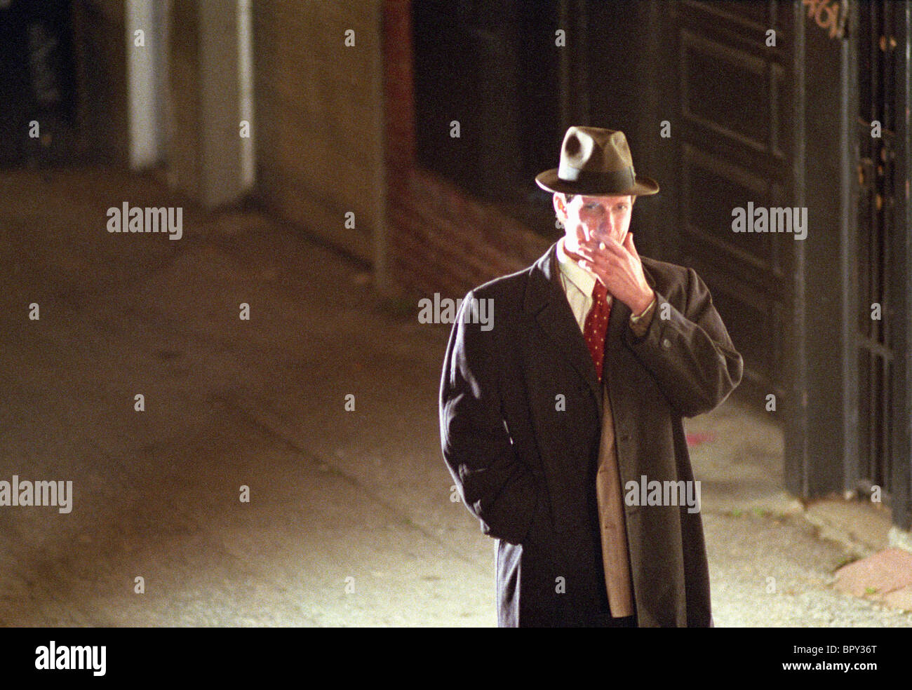 Business man smoking in alley at night Stock Photo - Alamy