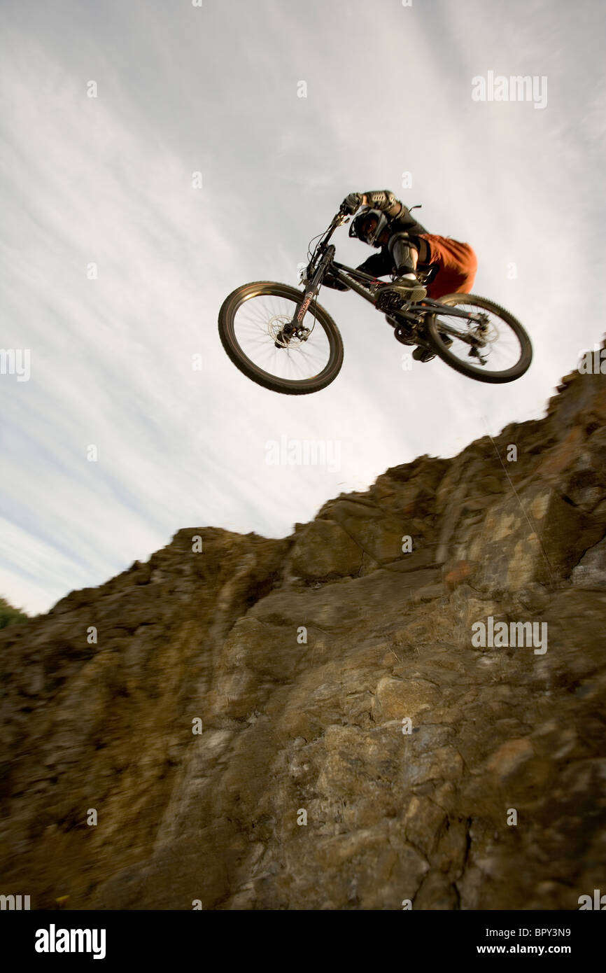 A man drops off a 20 foot cliff on a mountain bike outside of Hood ...
