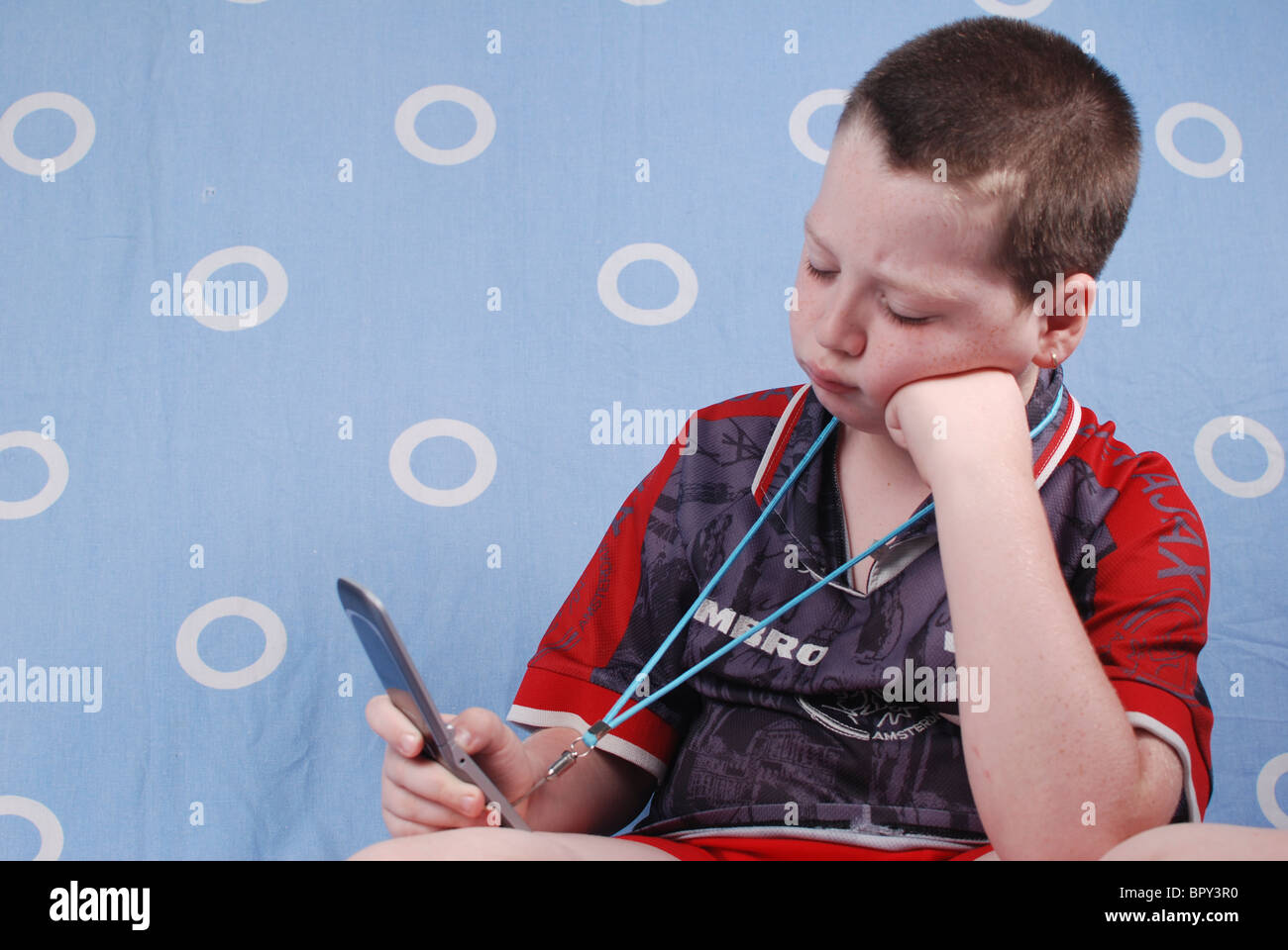 Bored child playing games hi-res stock photography and images - Alamy