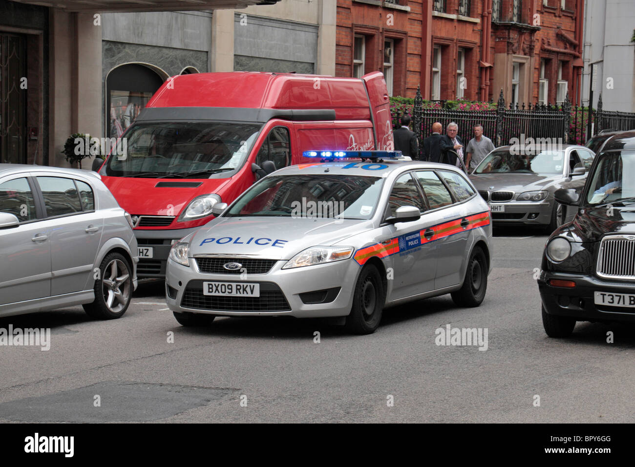 A Metropolitan Police car with flashing lights speeding down Brook ...