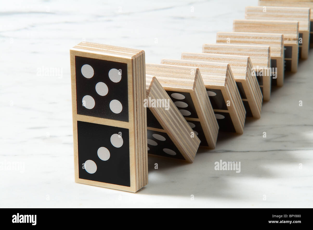 Line of domino tiles im motion Stock Photo - Alamy
