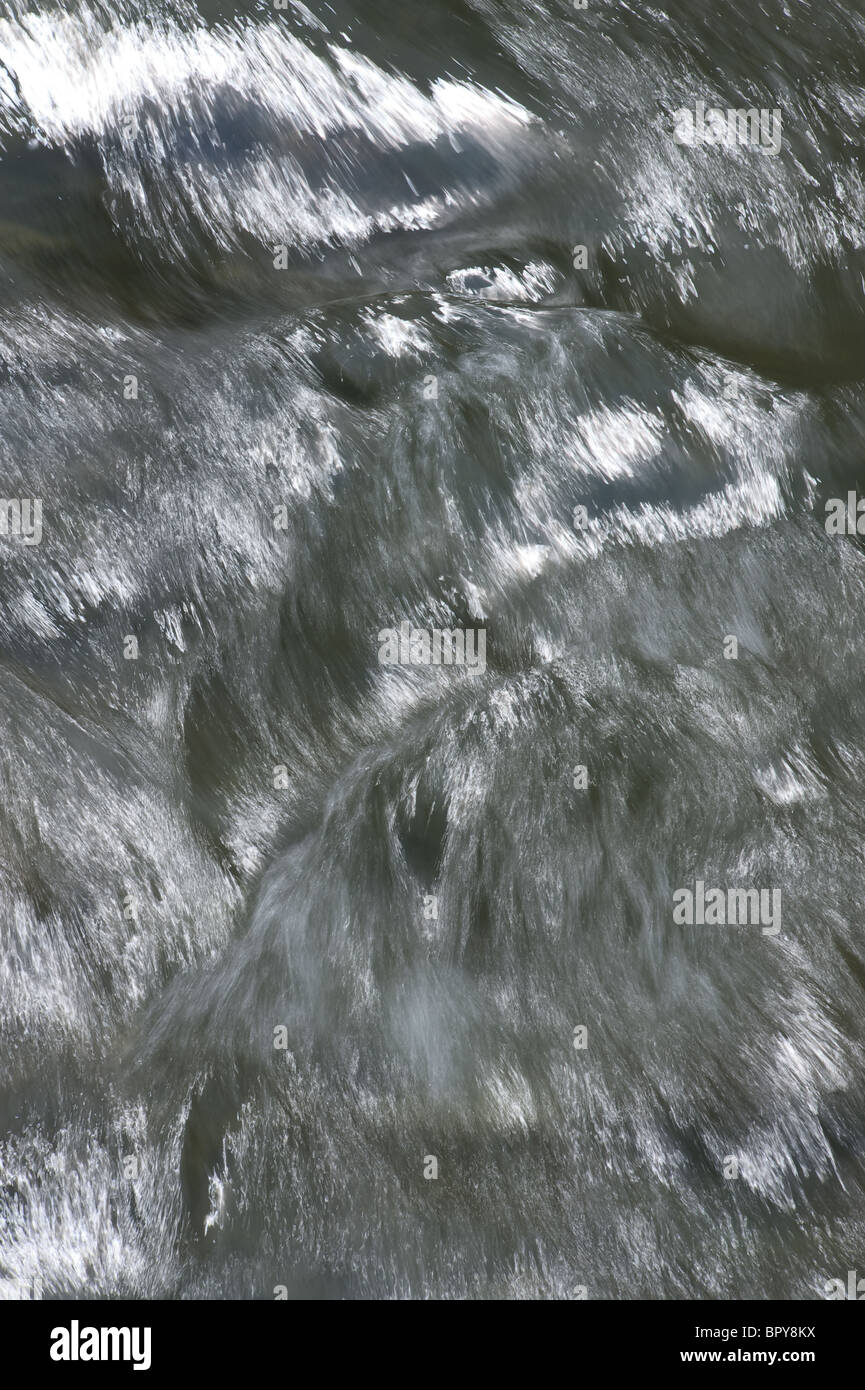 Flowing water with silver reflections from the sun Stock Photo - Alamy