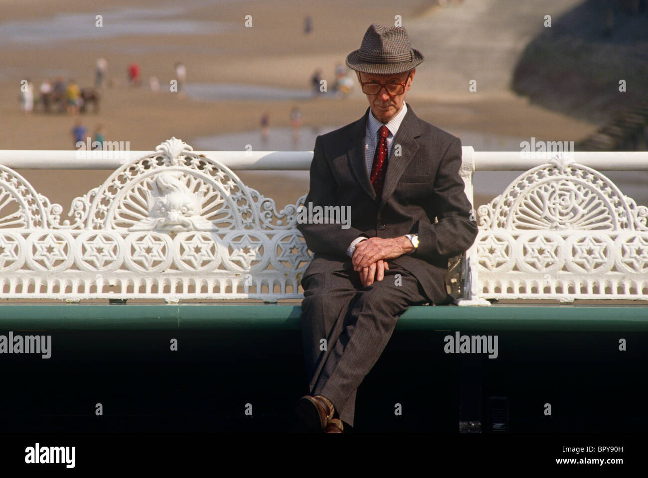 A rather eccentric-looking man seated on a bench on Blackpool's North ...