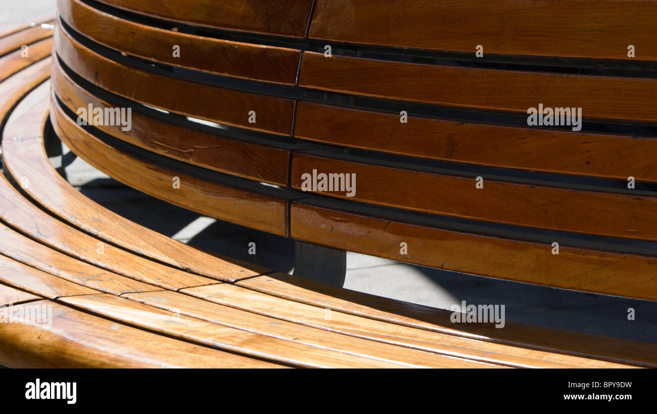 A curved wooden public bench in the shopping precinct of Oslo Denmark ...