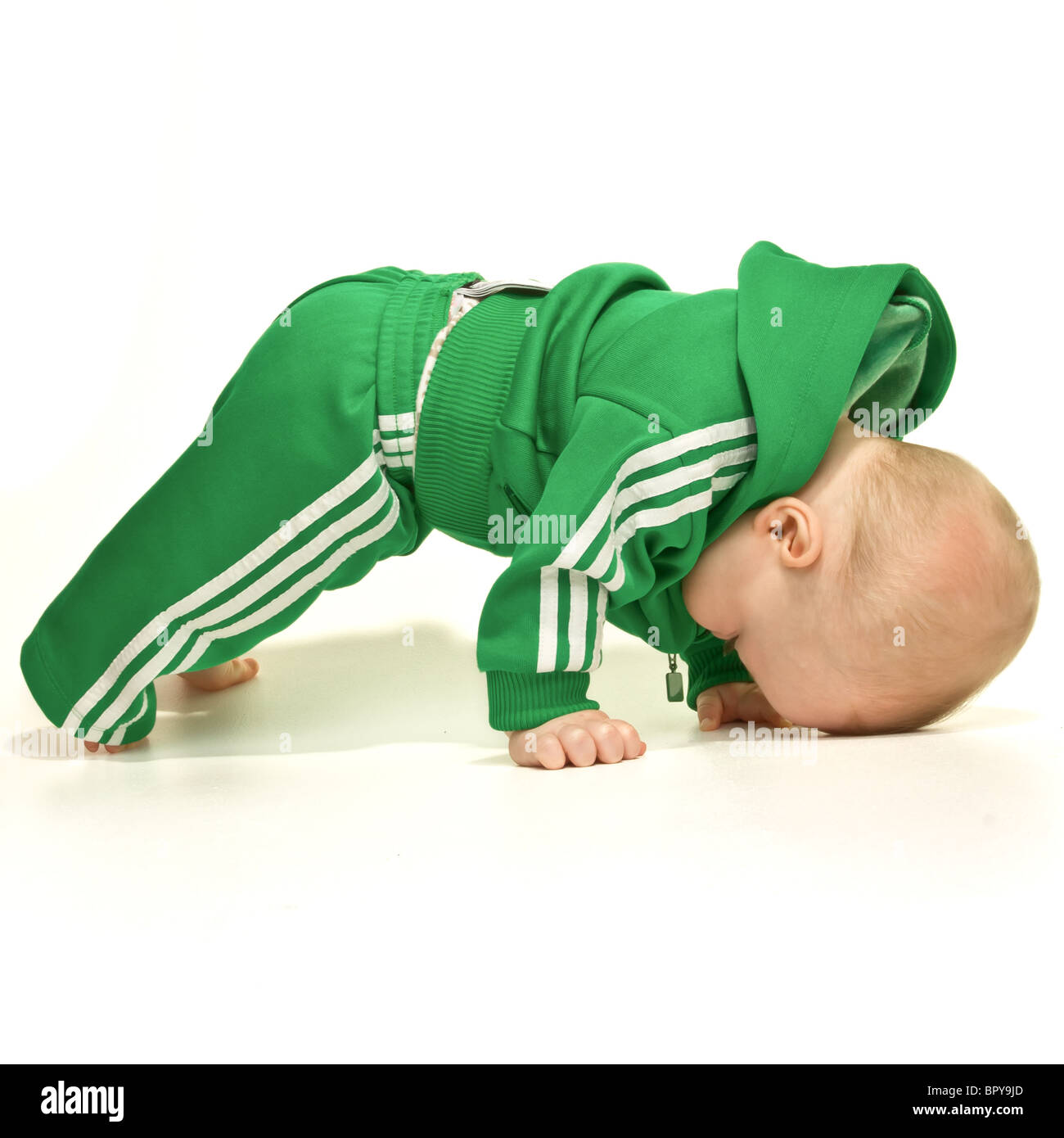 Cute expressive baby boy isolated on white background trying to stand ...