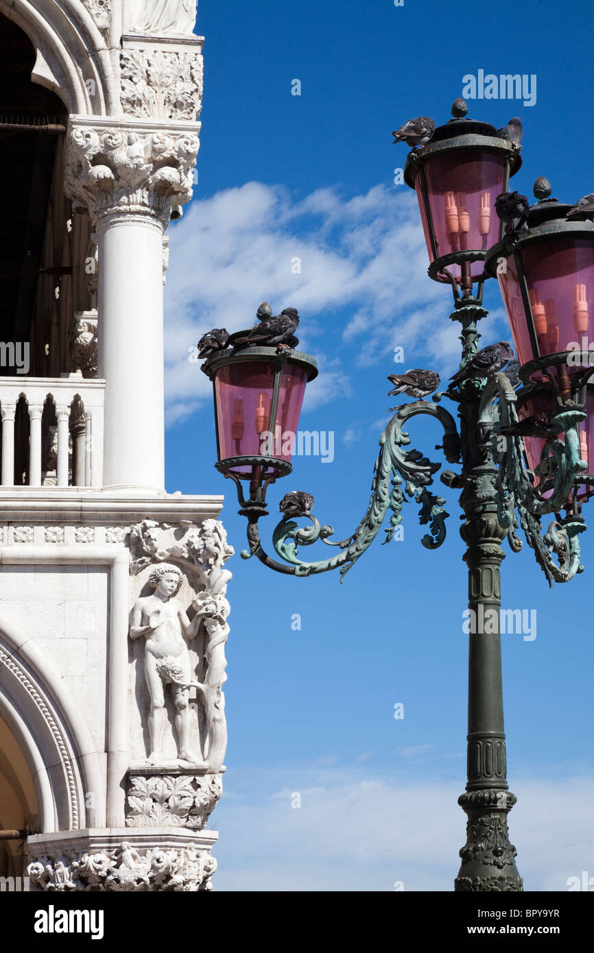 Carving on a building in St Mark's Square, Venice with lamp post and ...
