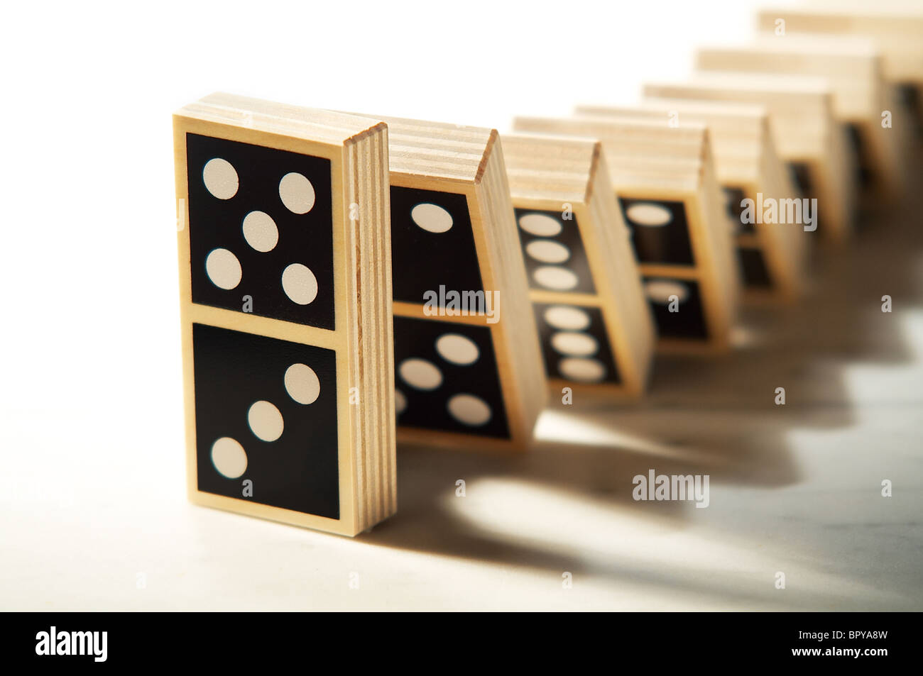 Line of domino tiles in motion Stock Photo - Alamy
