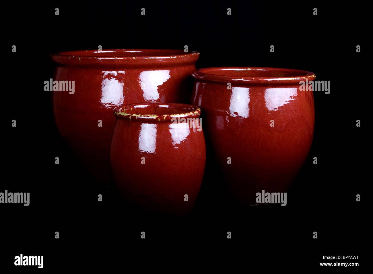 Three pots on a black background Stock Photo - Alamy