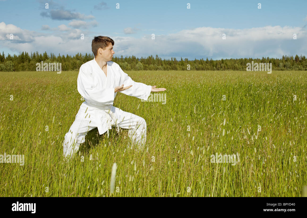 The young karateka trains in the open air Stock Photo - Alamy