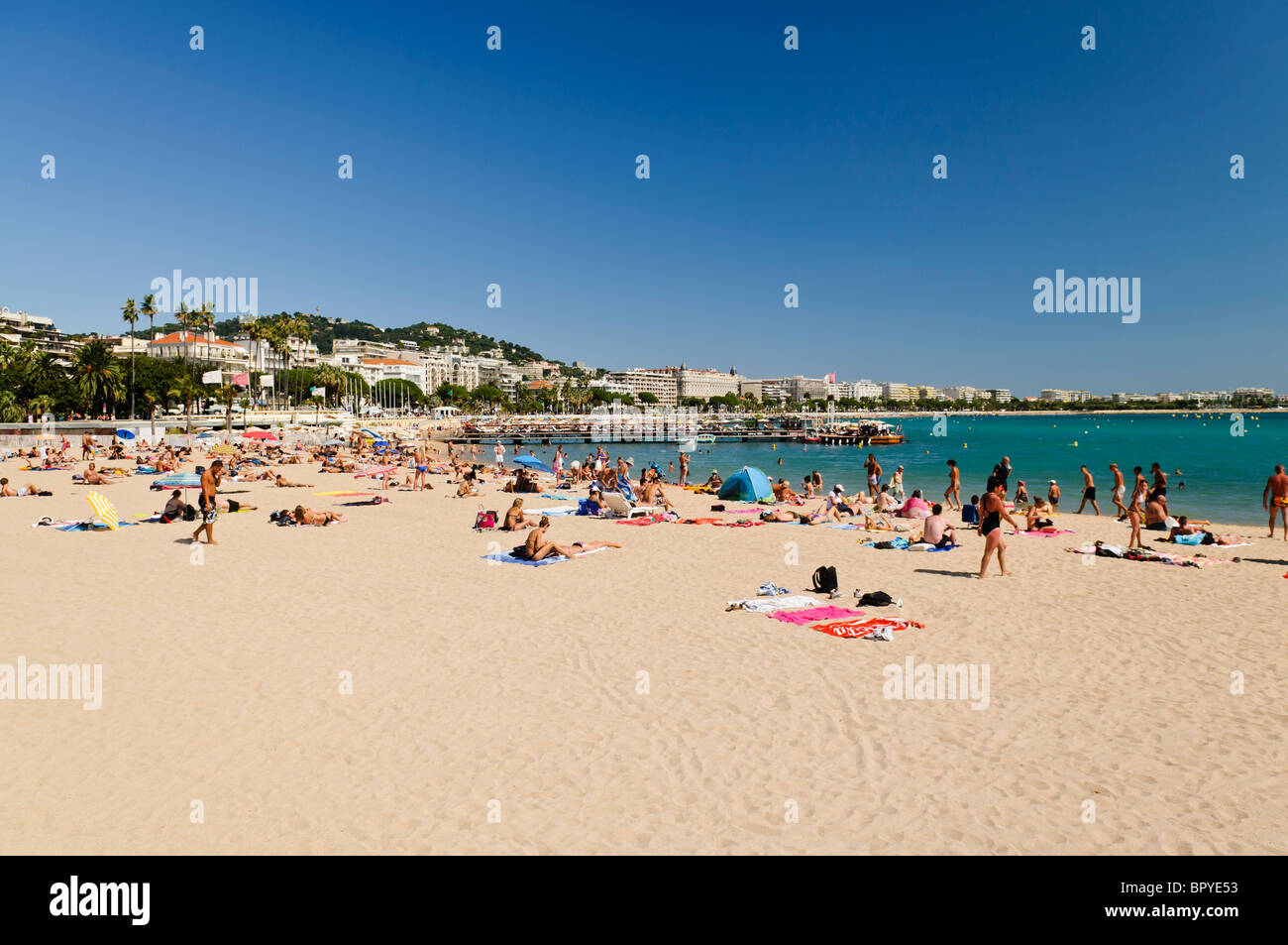 People sunbathing on the beach at Cannes, France Stock Photo - Alamy