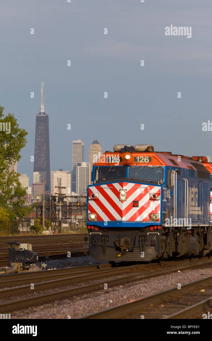 A Metra commuter train leaves Chicago for the suburbs with the John ...