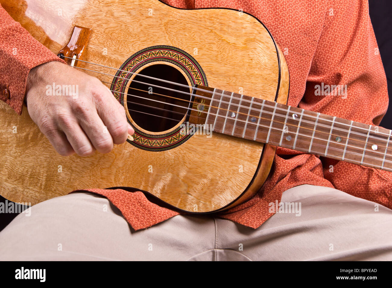 Acoustic guitar being played up close Stock Photo - Alamy