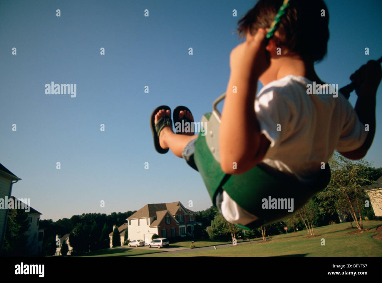child swinging on swing set Stock Photo - Alamy