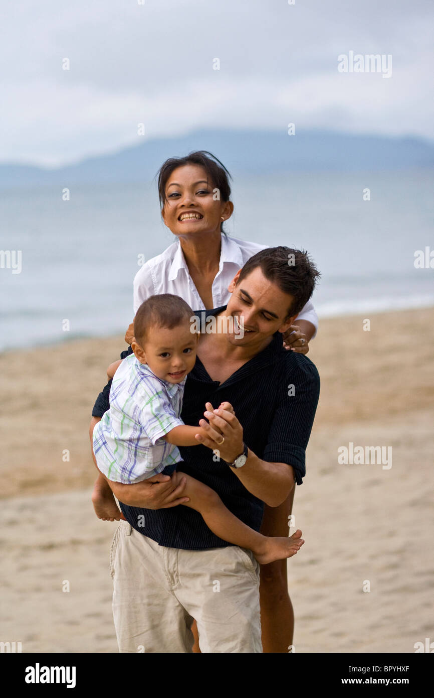 Mixed couple on the beach Stock Photo - Alamy