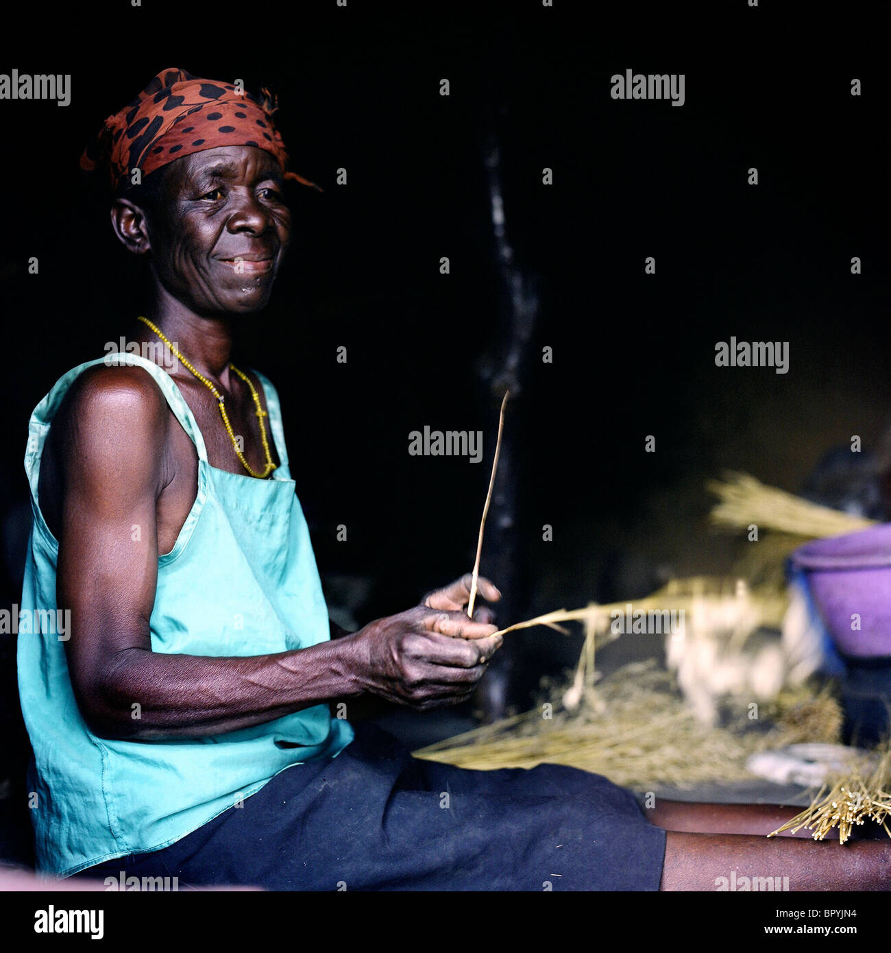 A woman doing brooms with bry straw branches Stock Photo - Alamy