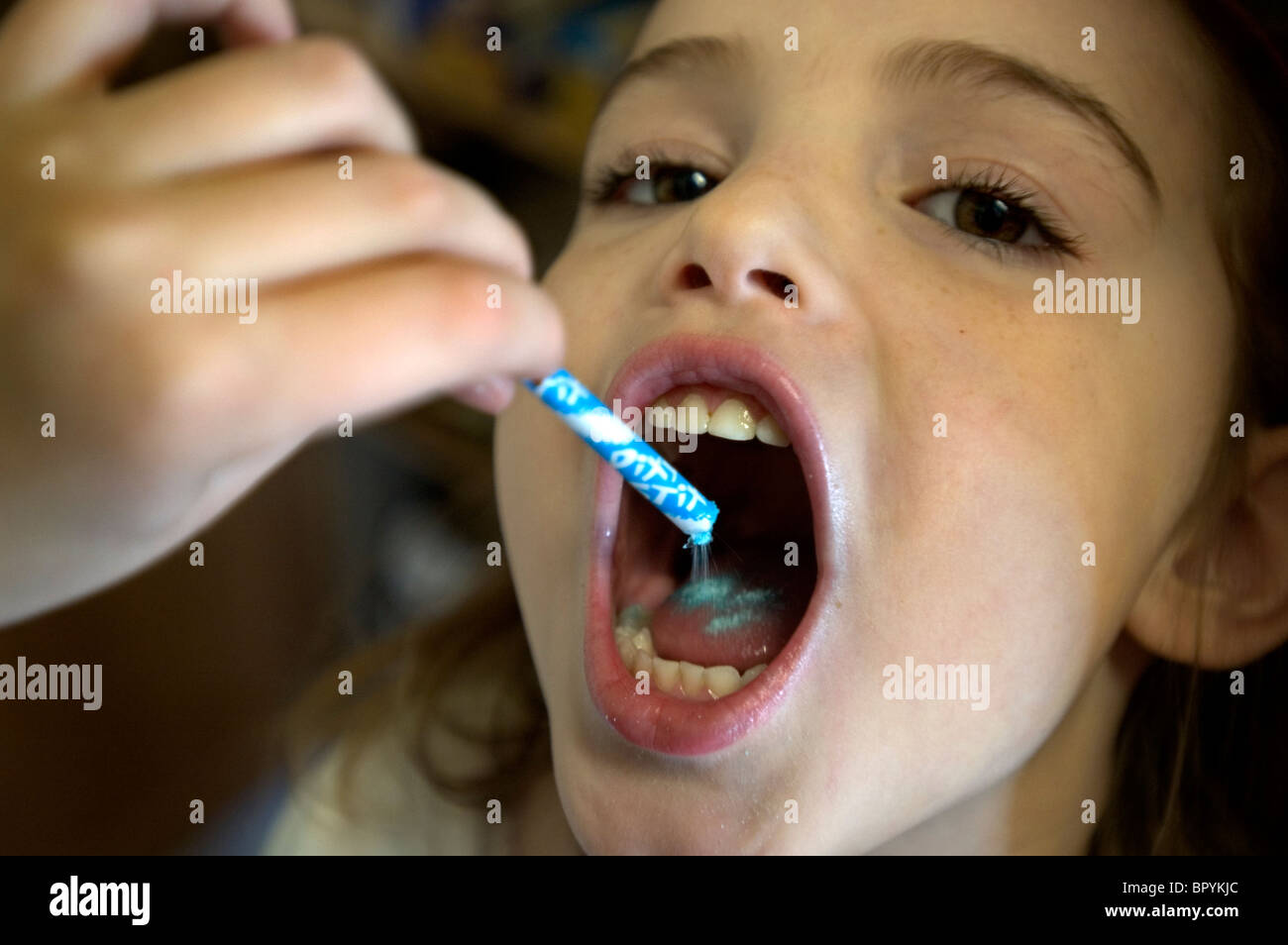 A young girl eats candy Stock Photo - Alamy