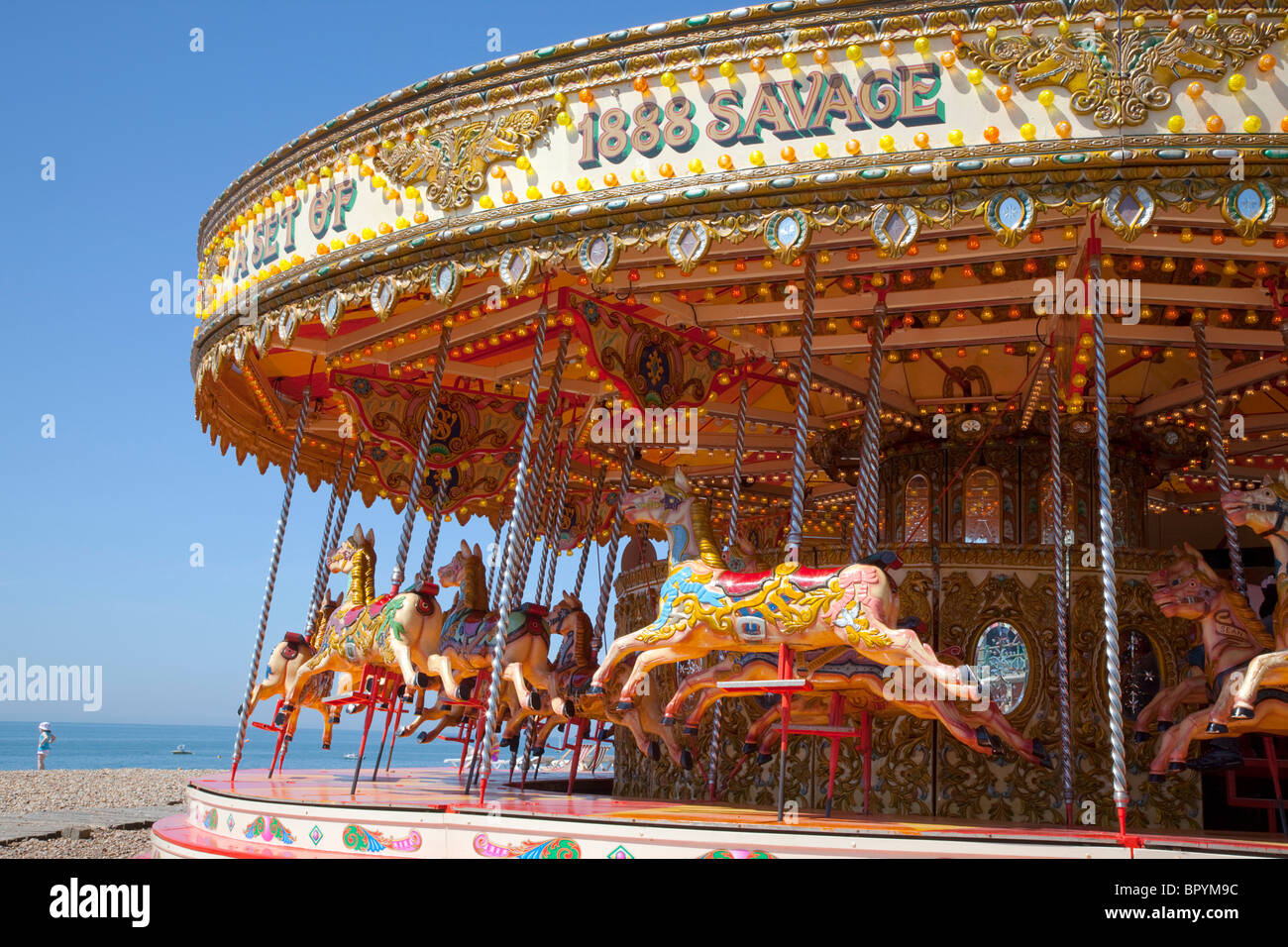 England, East Sussex, Brighton, Carousel on the pebble beach promenade ...