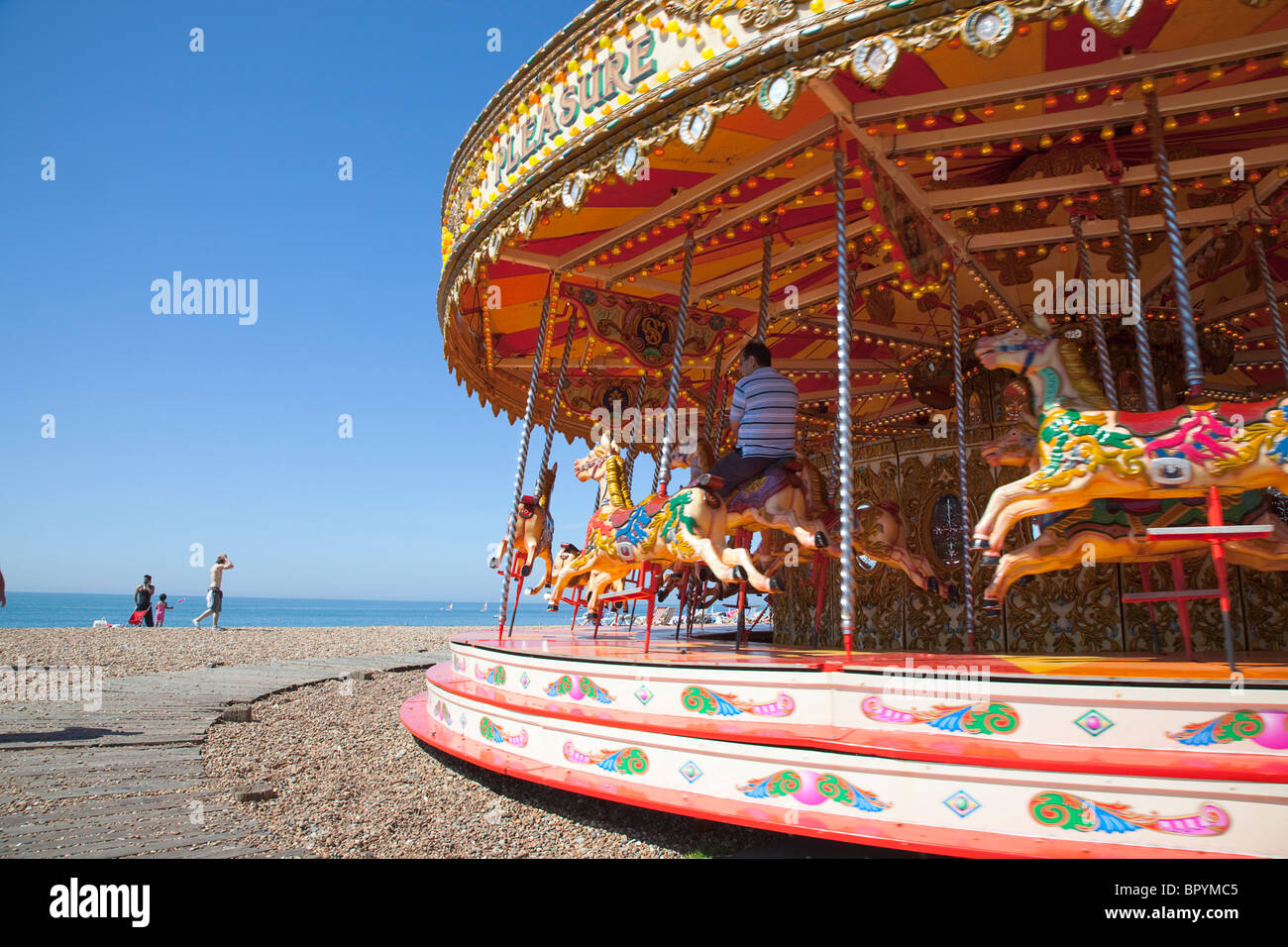 England, East Sussex, Brighton, Carousel on the pebble beach promenade ...
