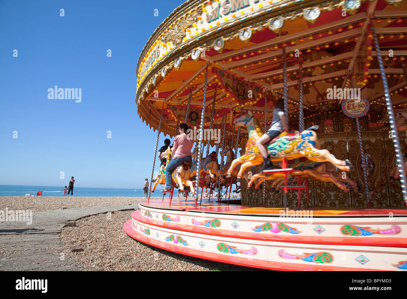England, East Sussex, Brighton, Carousel on the pebble beach promenade ...