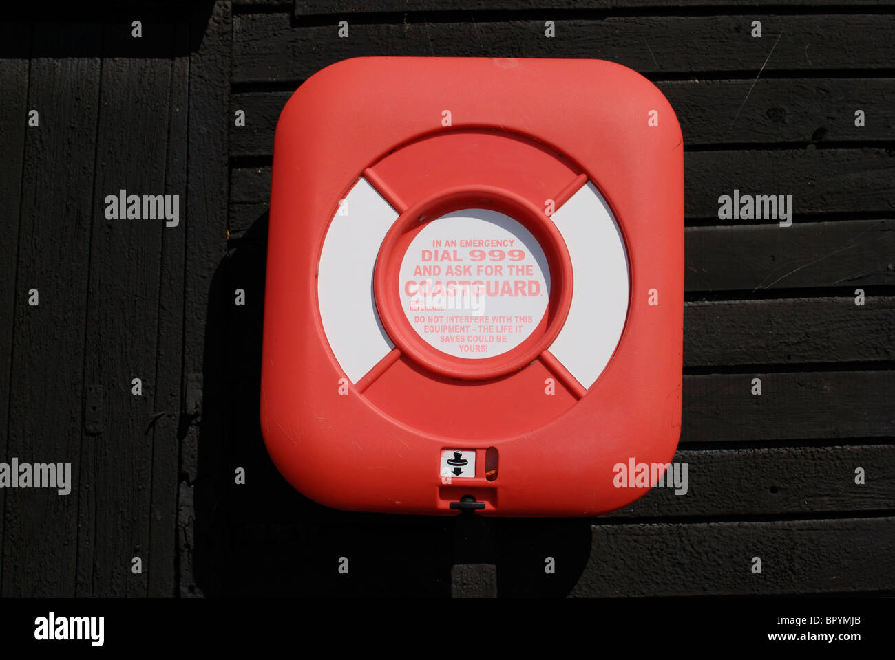 Red Lifebelt (lifesaver) equipment on black wooden building at Bosham ...