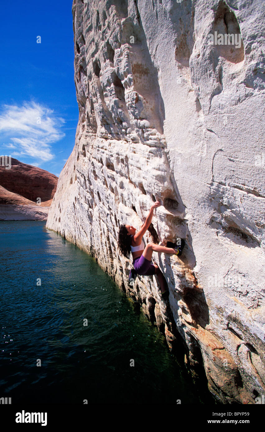 A woman bouldering in a gorgeous bouldering area above water Stock ...