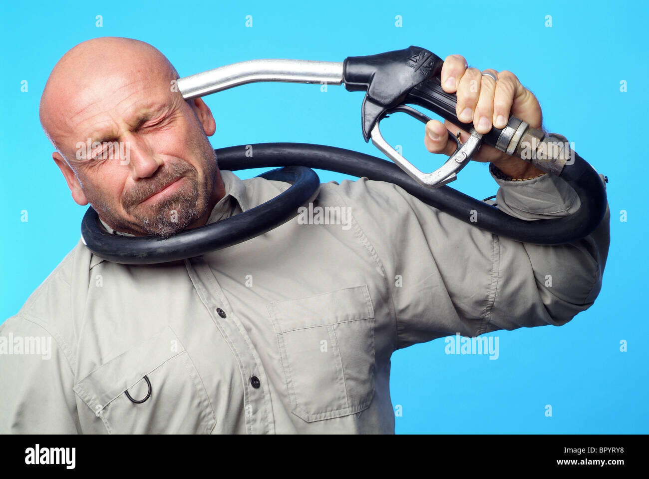 Man holding gas pump head hi-res stock photography and images - Alamy