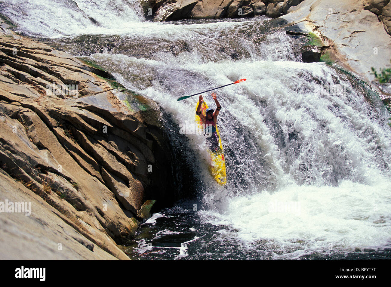 A man goes over a waterfall in a kayak Stock Photo - Alamy