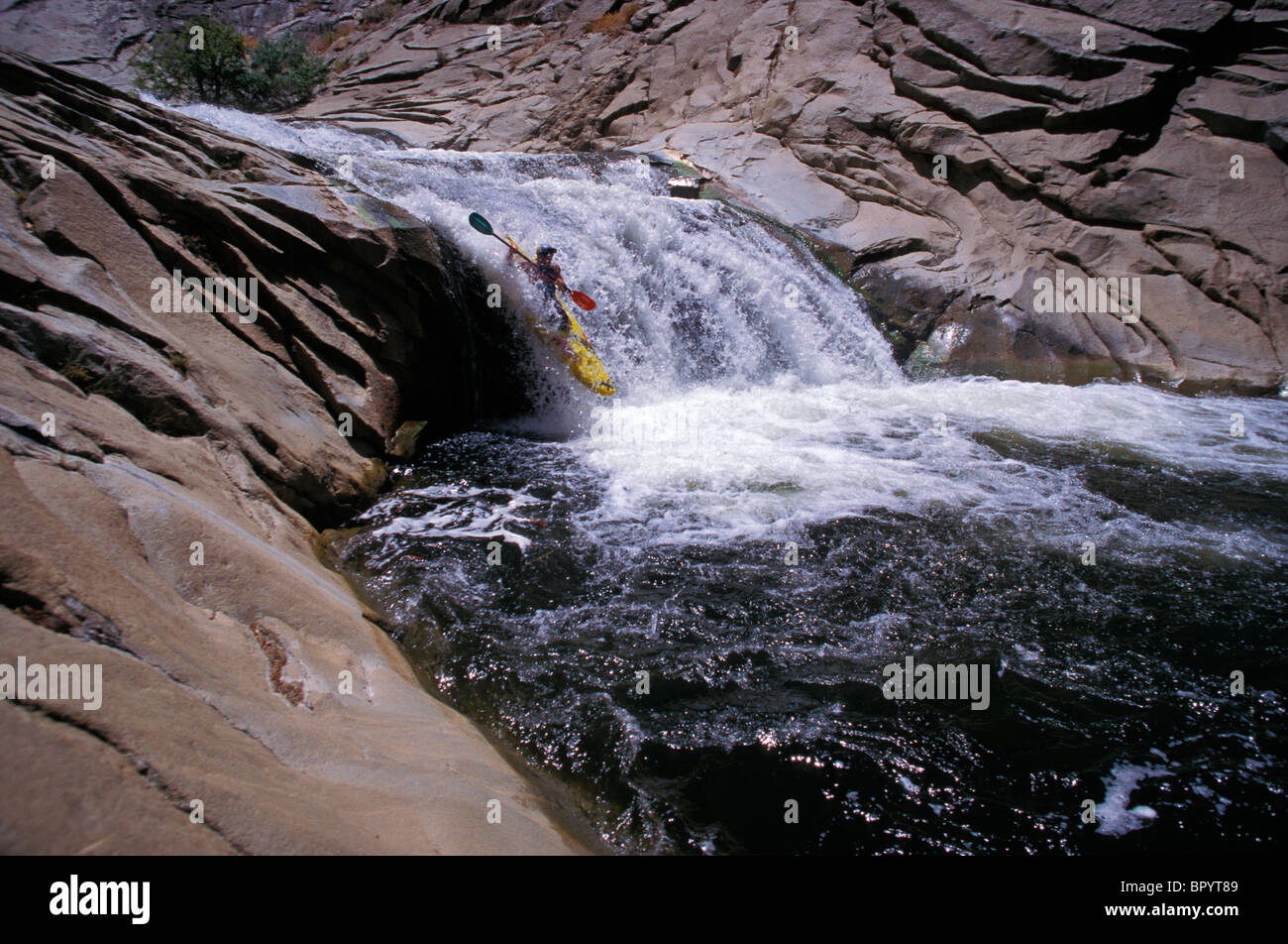 A man goes over a waterfall in his kayak Stock Photo - Alamy