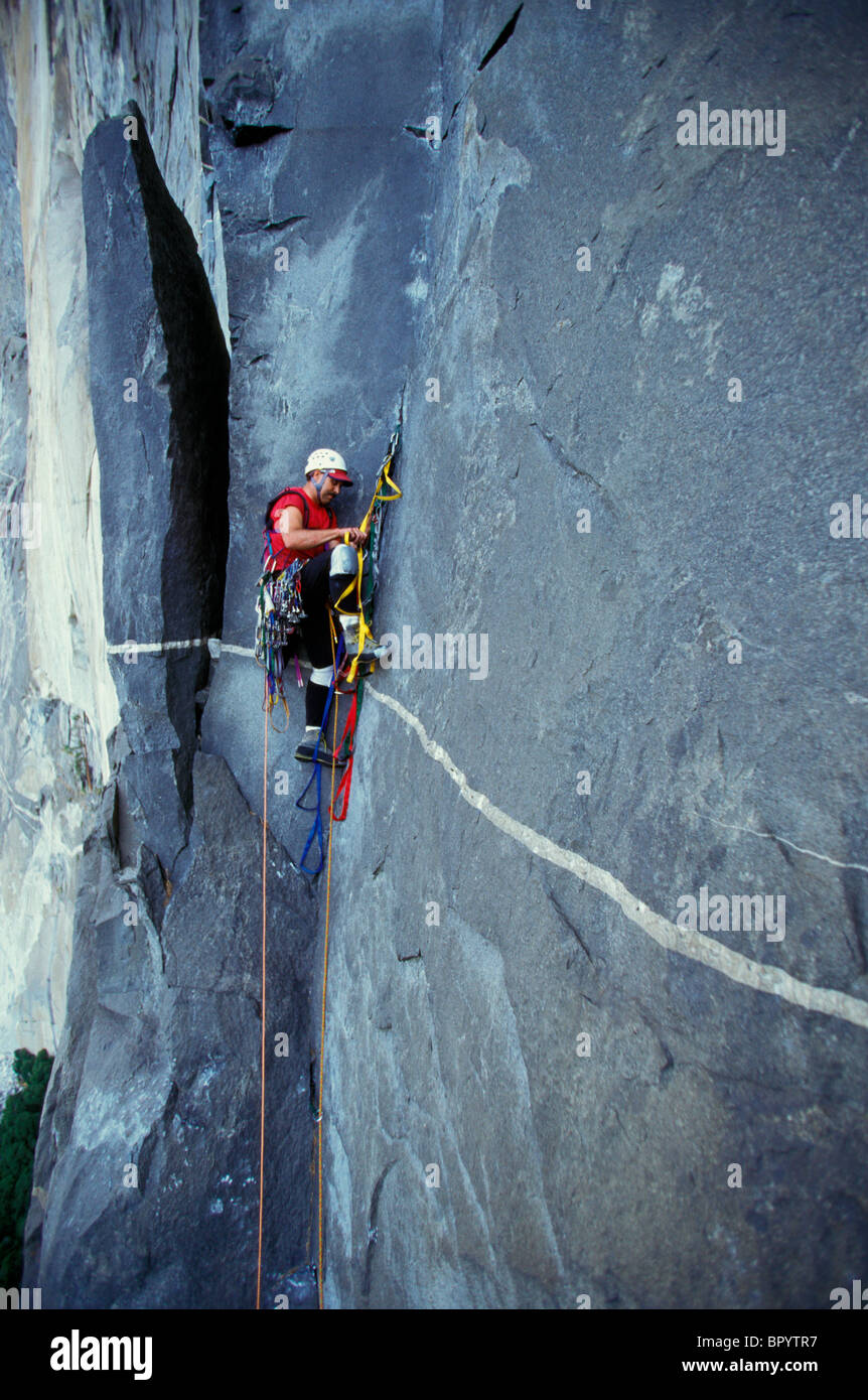 A man placing gear while aid climbing Stock Photo - Alamy