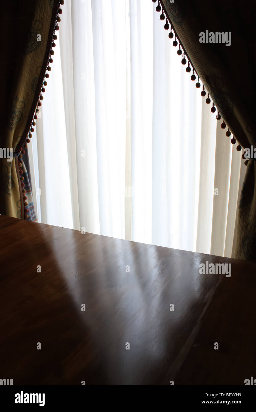 curtain light dark wooden desk Stock Photo - Alamy