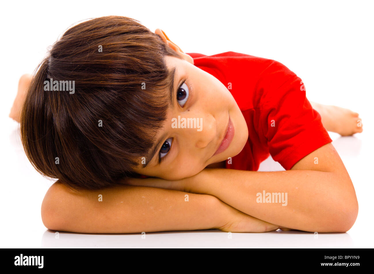 Cute Child lying down on the white floor Stock Photo - Alamy